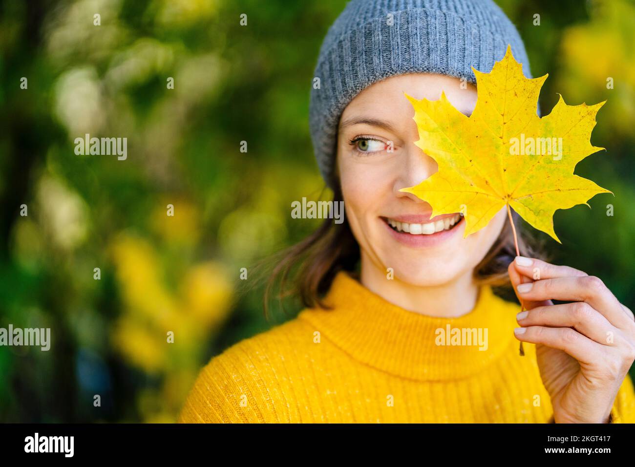 Woman holding leaf over head hi-res stock photography and images - Alamy