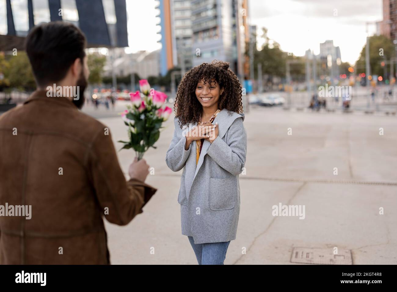 Man giving girlfriend flowers outdoors hi-res stock photography and ...