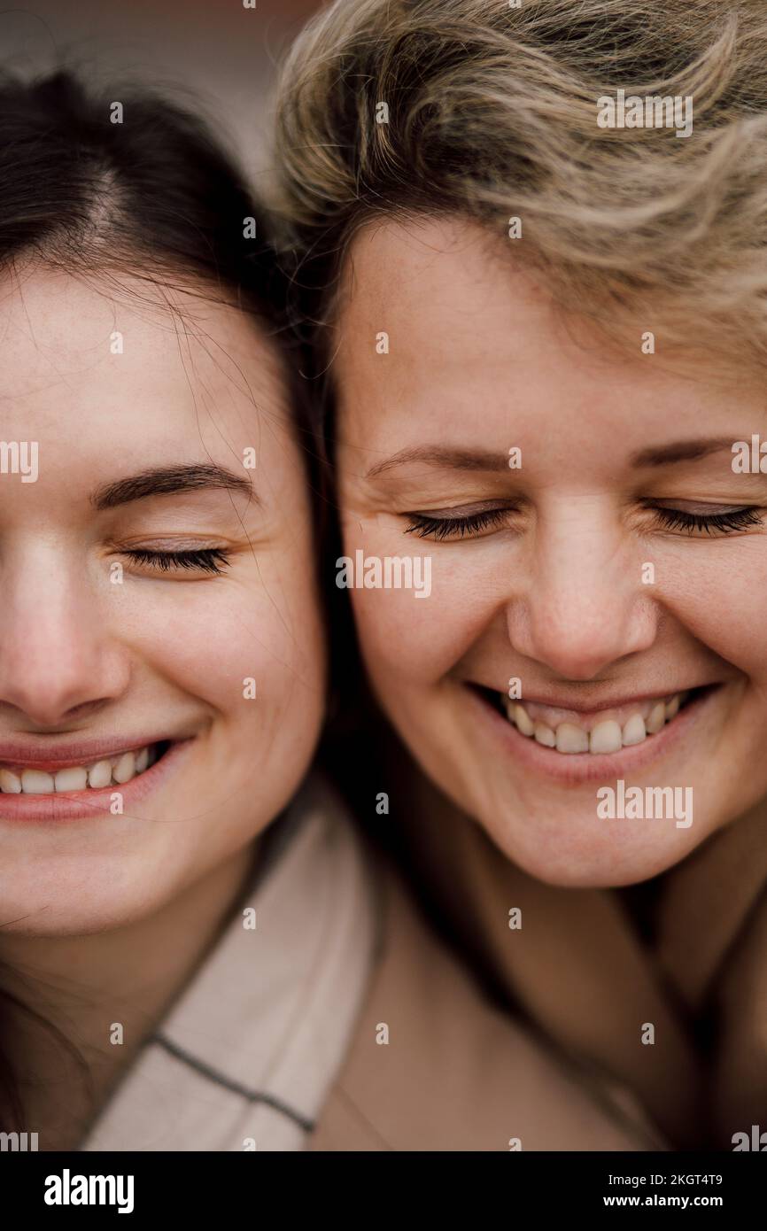 Happy mother and daughter with eyes closed Stock Photo - Alamy