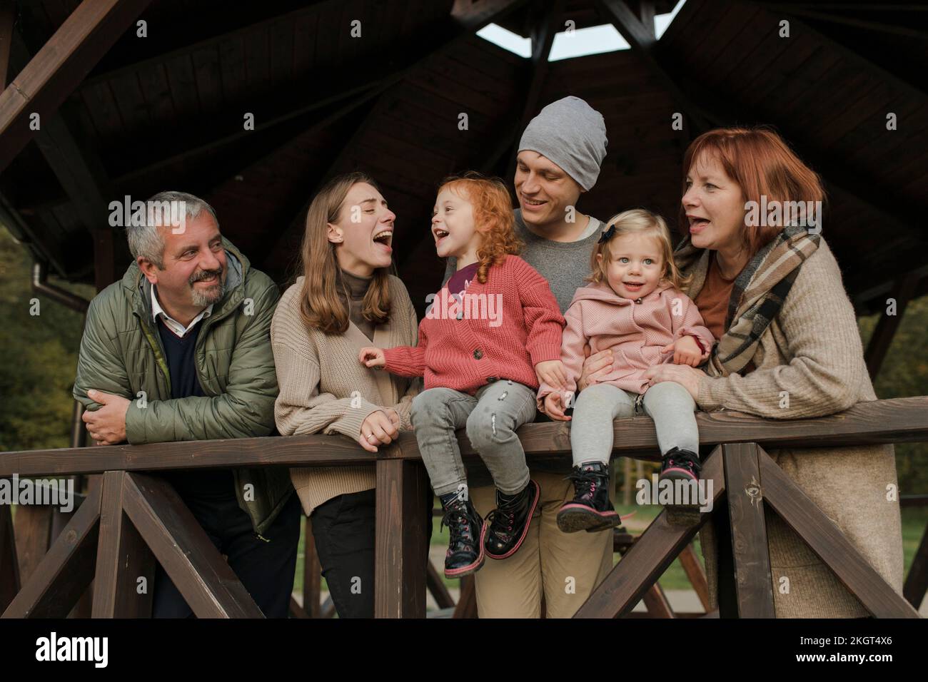 Cheerful family screaming together by railing Stock Photo - Alamy