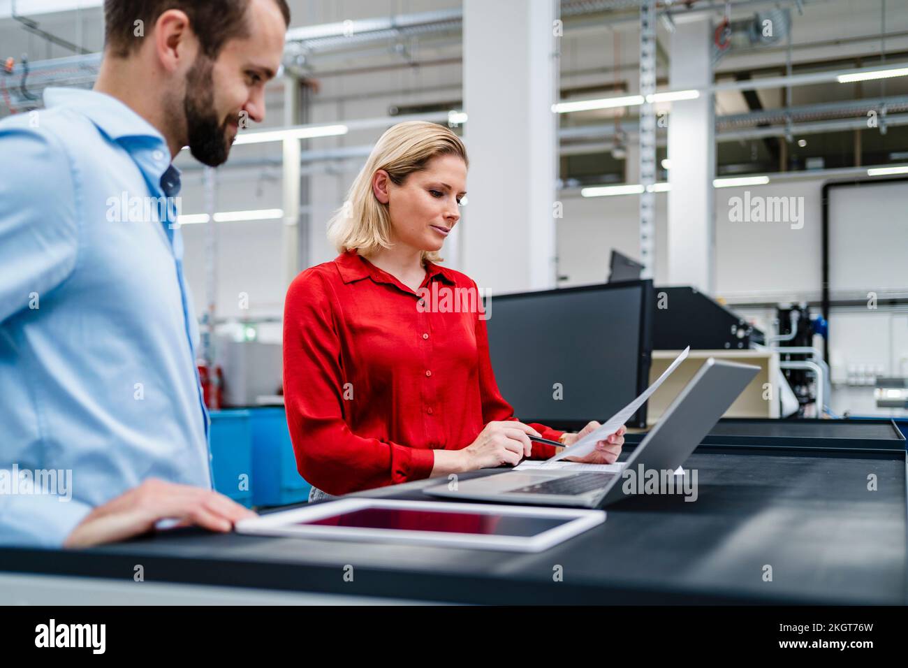 Reviewing business colleagues examining hi-res stock photography and ...