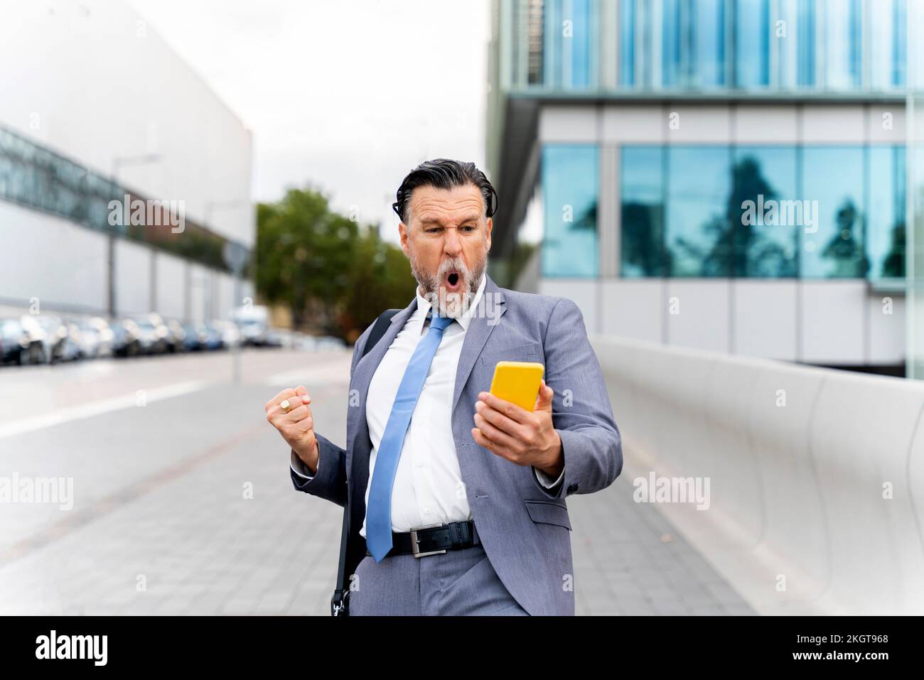 Excited male standing mobile phone hi-res stock photography and images ...