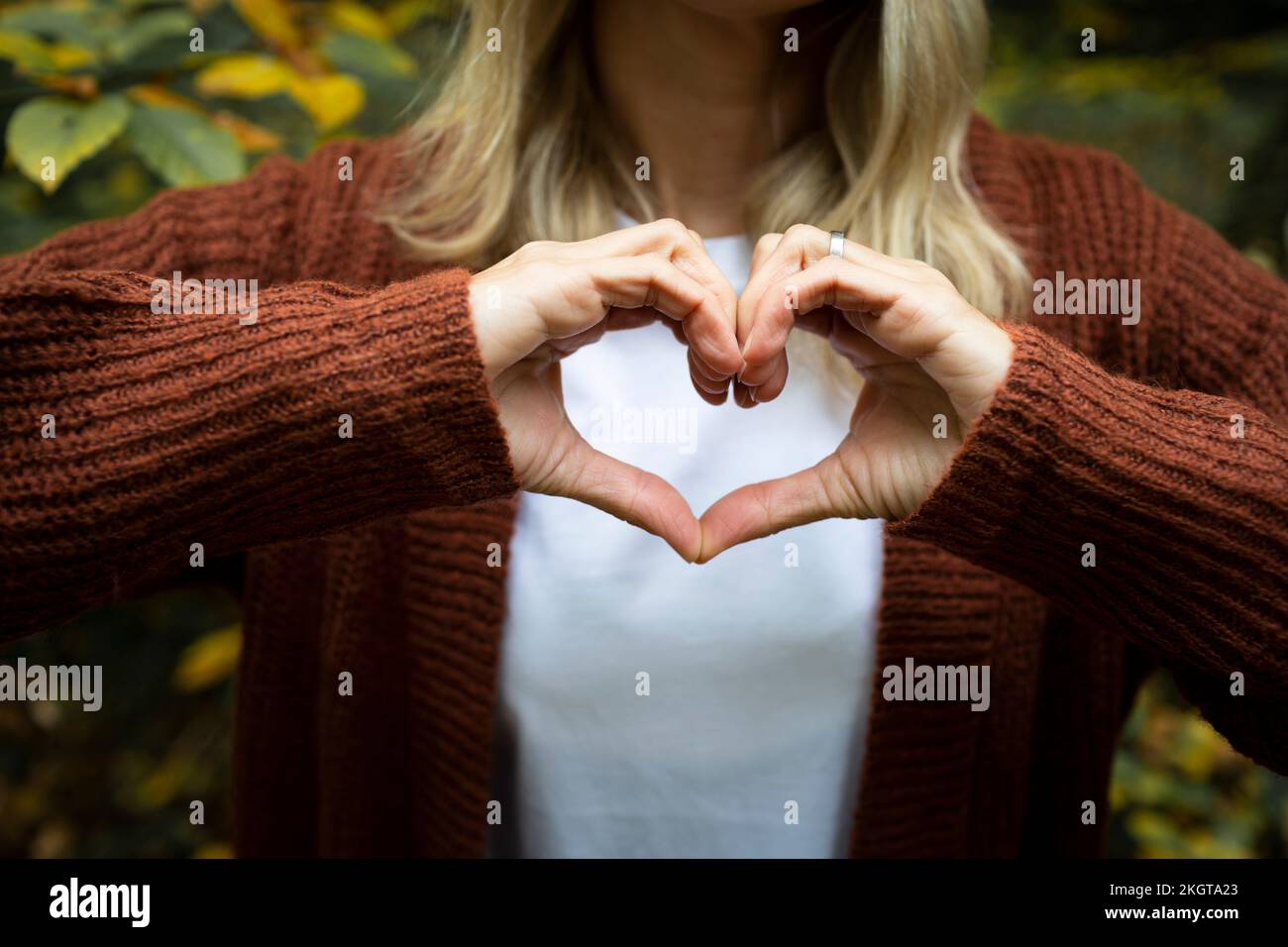 Mature woman making heart shape hi-res stock photography and images - Alamy