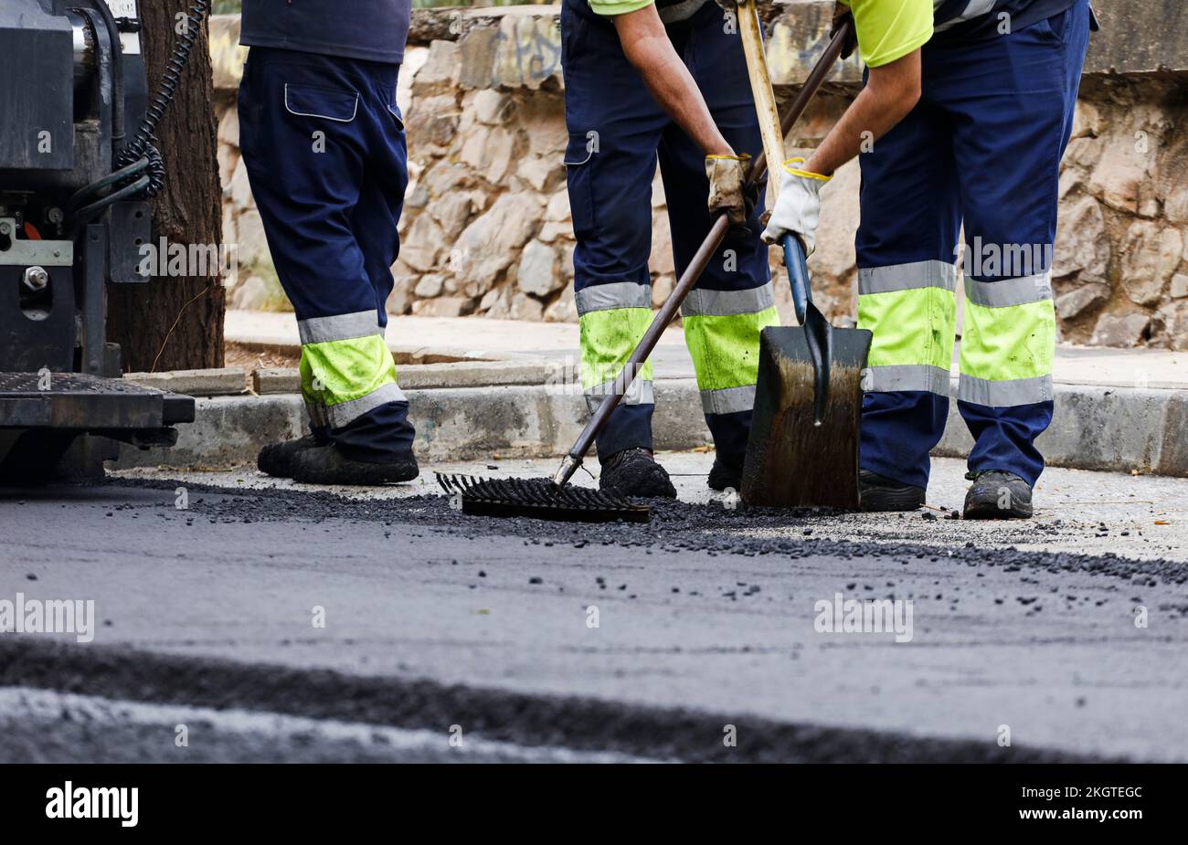 operators and road paving machines, freshly laid new asphalt Stock ...
