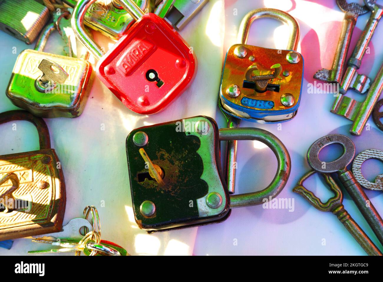 Ancient padlocks and keys and sunbeam on locks with white background ...