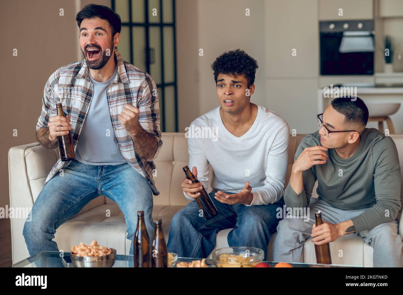 Excited viewers rooting for their favorite team Stock Photo - Alamy