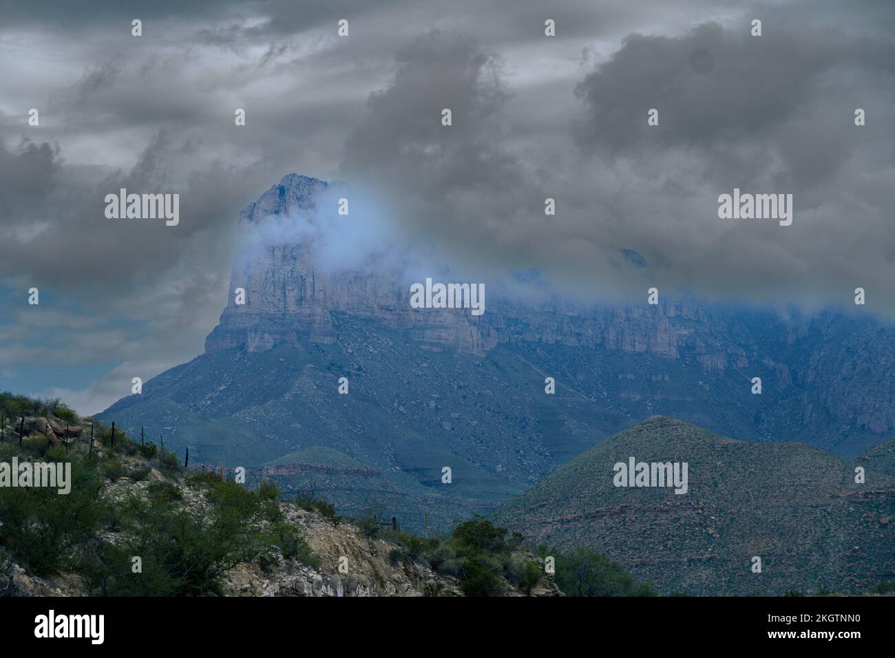 A scenic view of a rocky cliff found in nature on a foggy day Stock ...