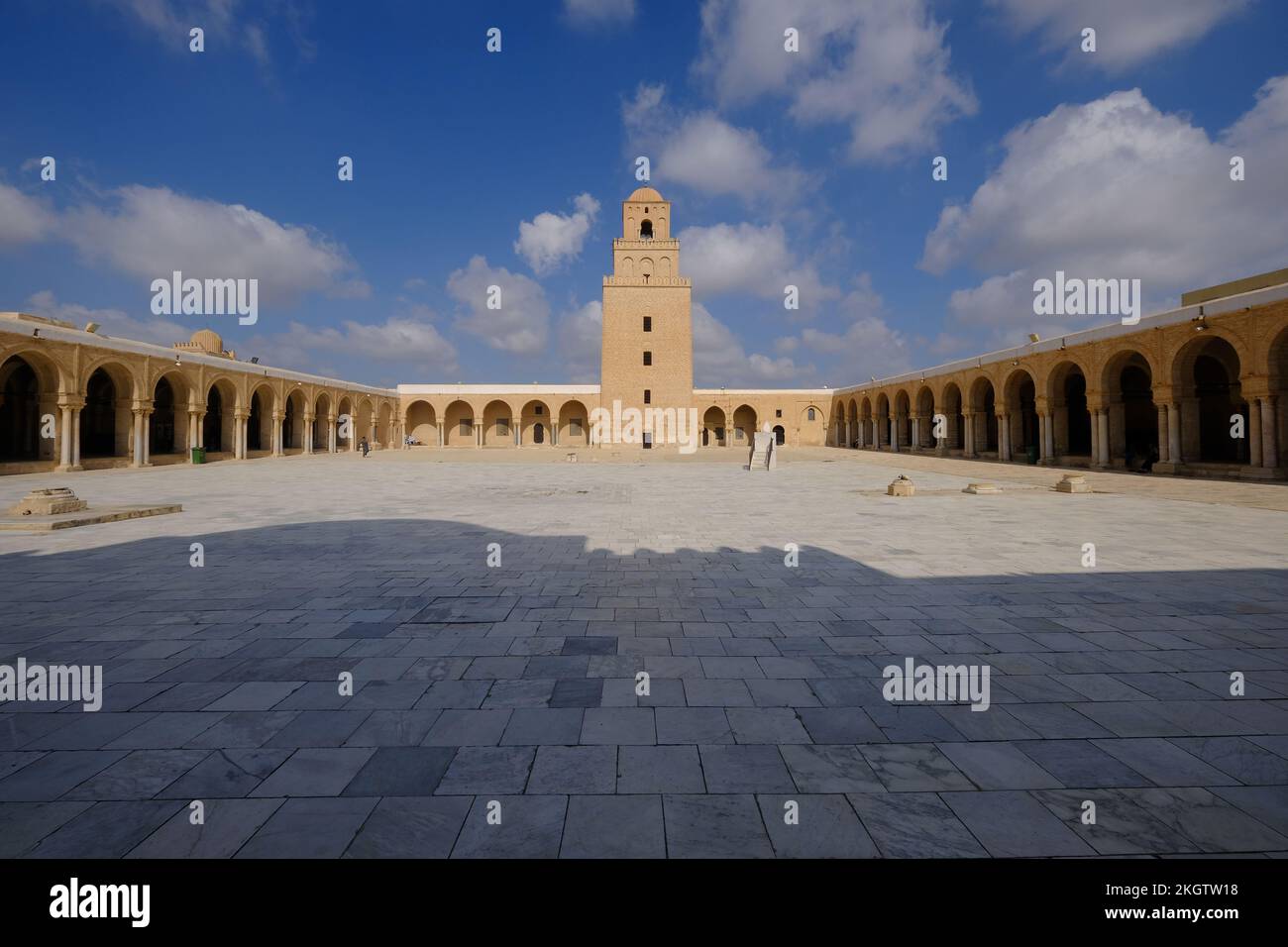 Facade of the ancient Great Mosque and sundial in Kairouan against blue ...