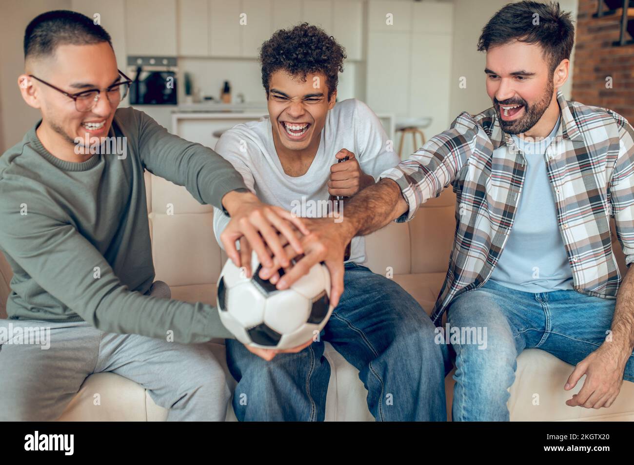 Football team putting hands together hi-res stock photography and ...