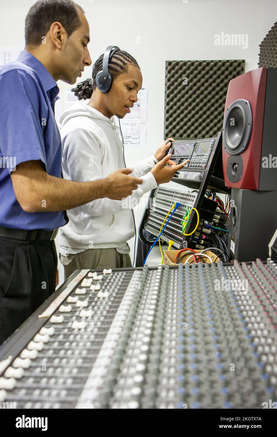 Music Students: Studio Session. A budding music producer being ...