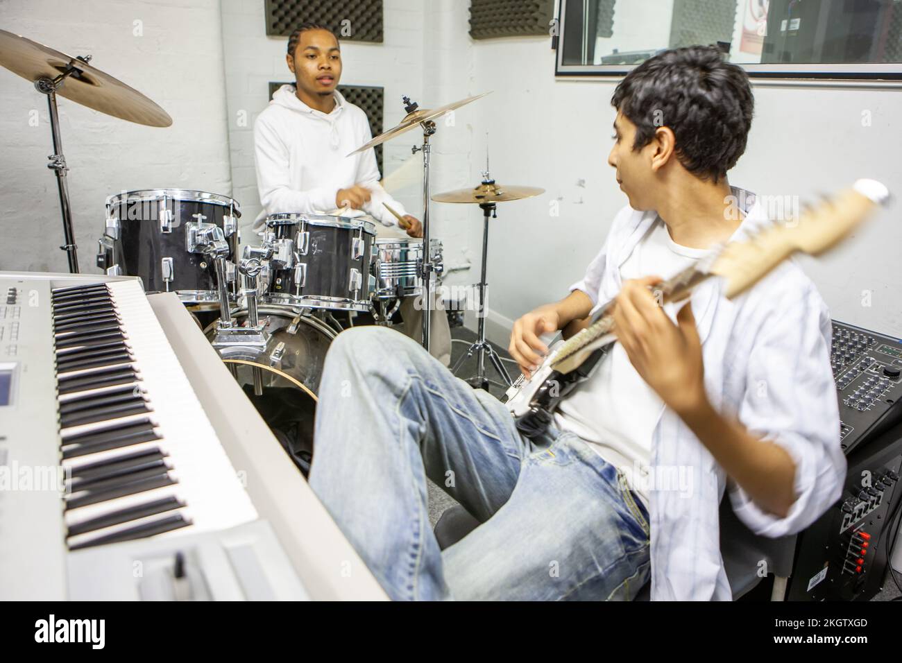 Music Students: Jamming Session. A guitarist and drummer rehearsing ...
