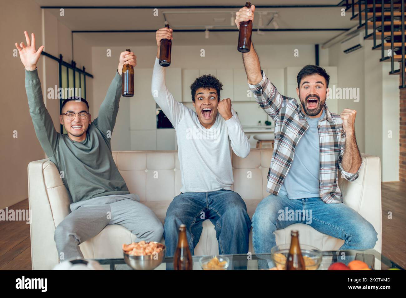 Company of friends enjoying a TV show Stock Photo - Alamy