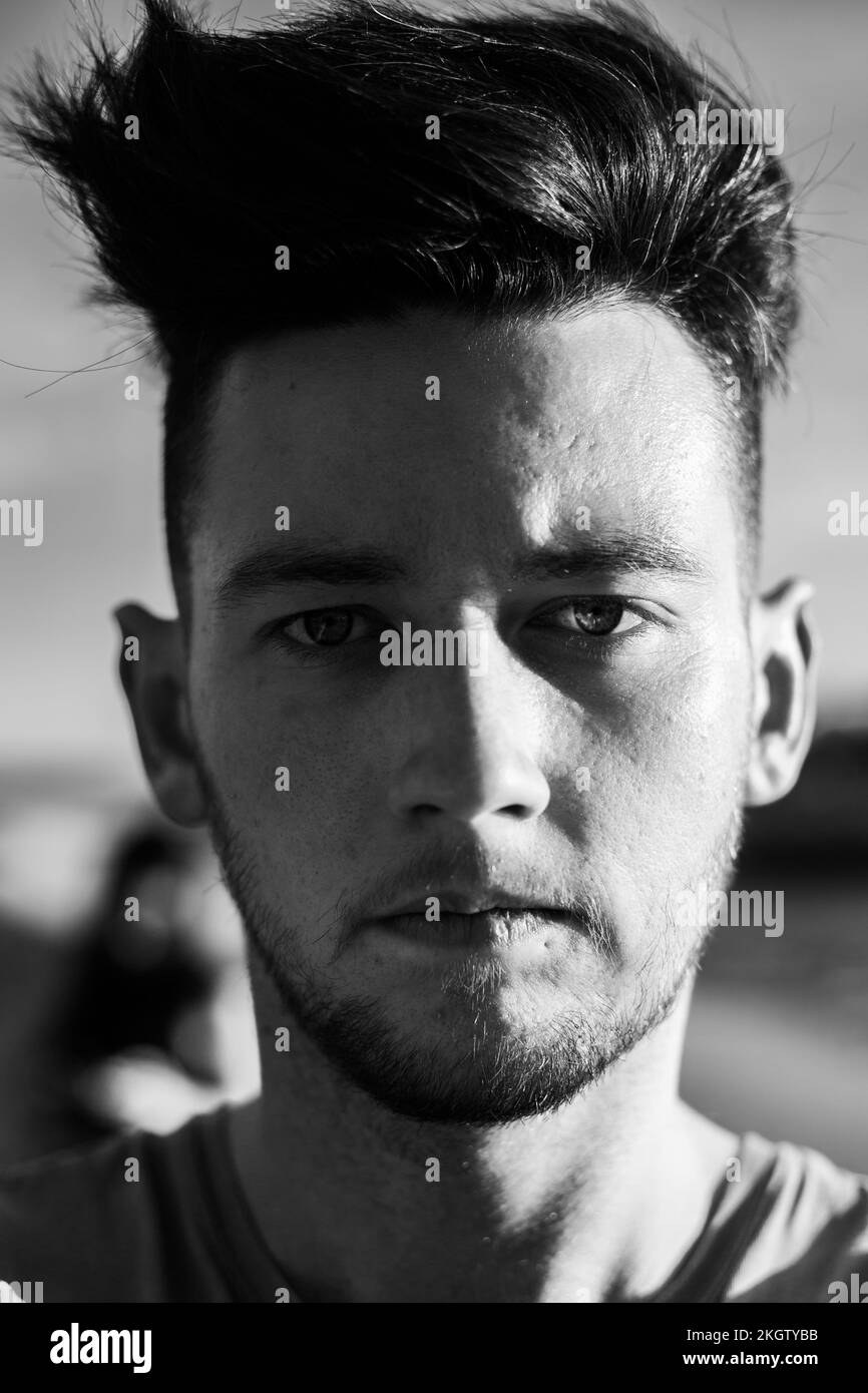 A grayscale portrait of a Caucasian male face by lighting with blur ...