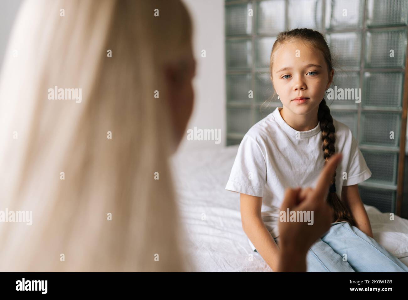 Close-up back view of unrecognizable mom scolding, raising voice ...