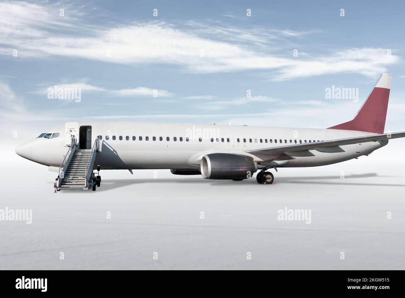 Passenger jet plane with a stairway on bright background with sky Stock ...