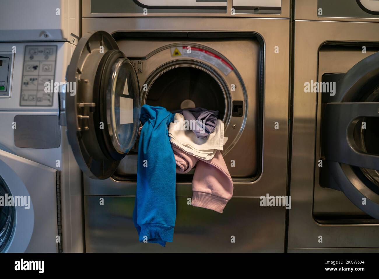 Automatic front-loading washing machine at a public launderette Stock ...