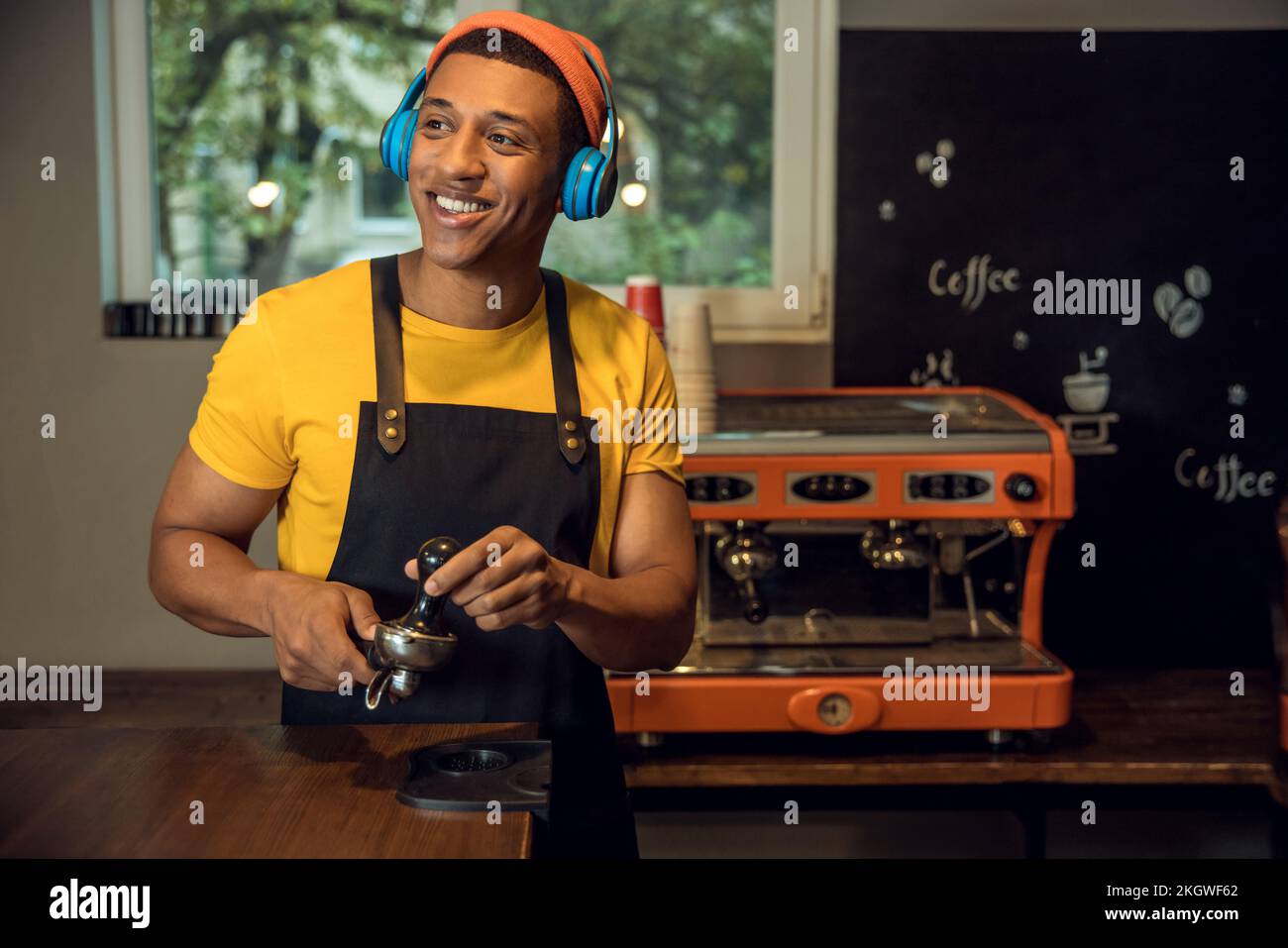 Cafe worker making a caffeinated drink to his favorite music Stock ...