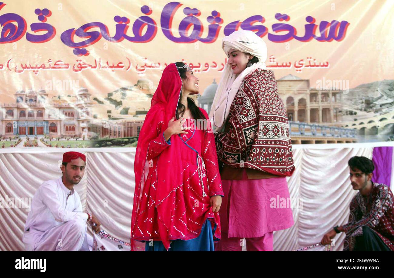 Students are presenting tableaus on stage during a ceremony on the eve of Sindhi Cultural Day ...