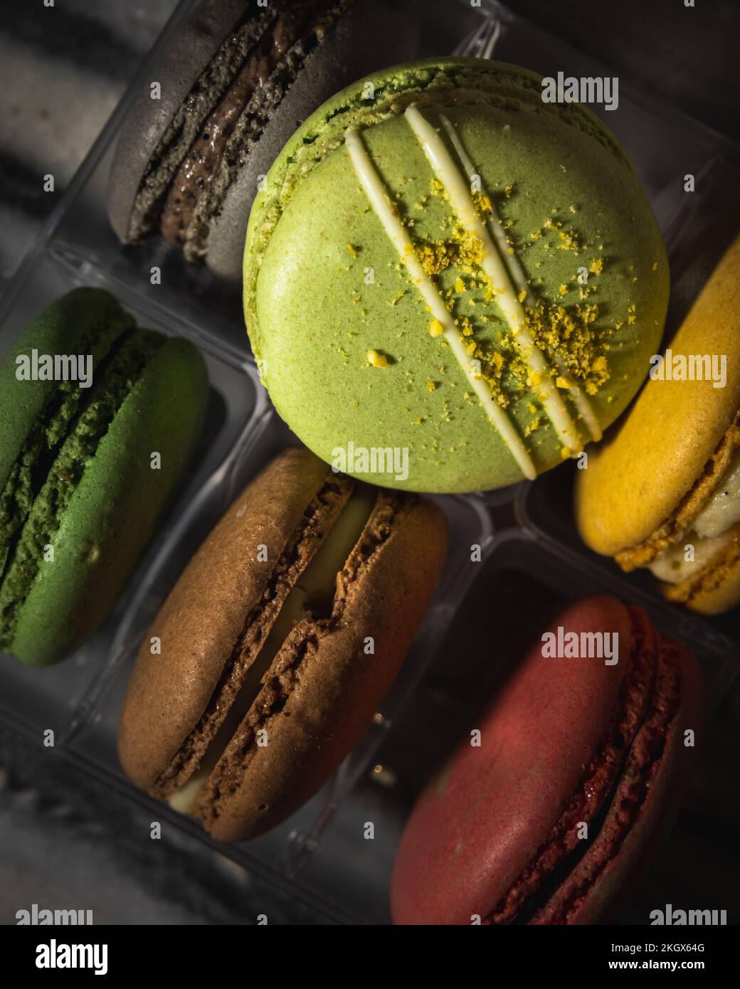 The vertical top view of colorful French macarons in a box Stock Photo ...