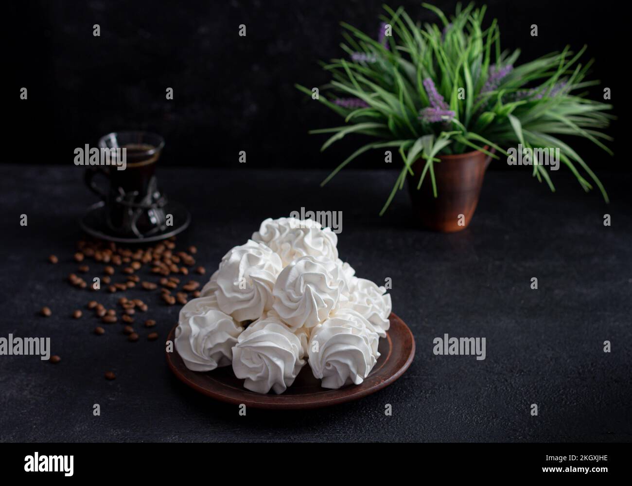 zepfyr on a dark background in a plate in the background - a cup of ...