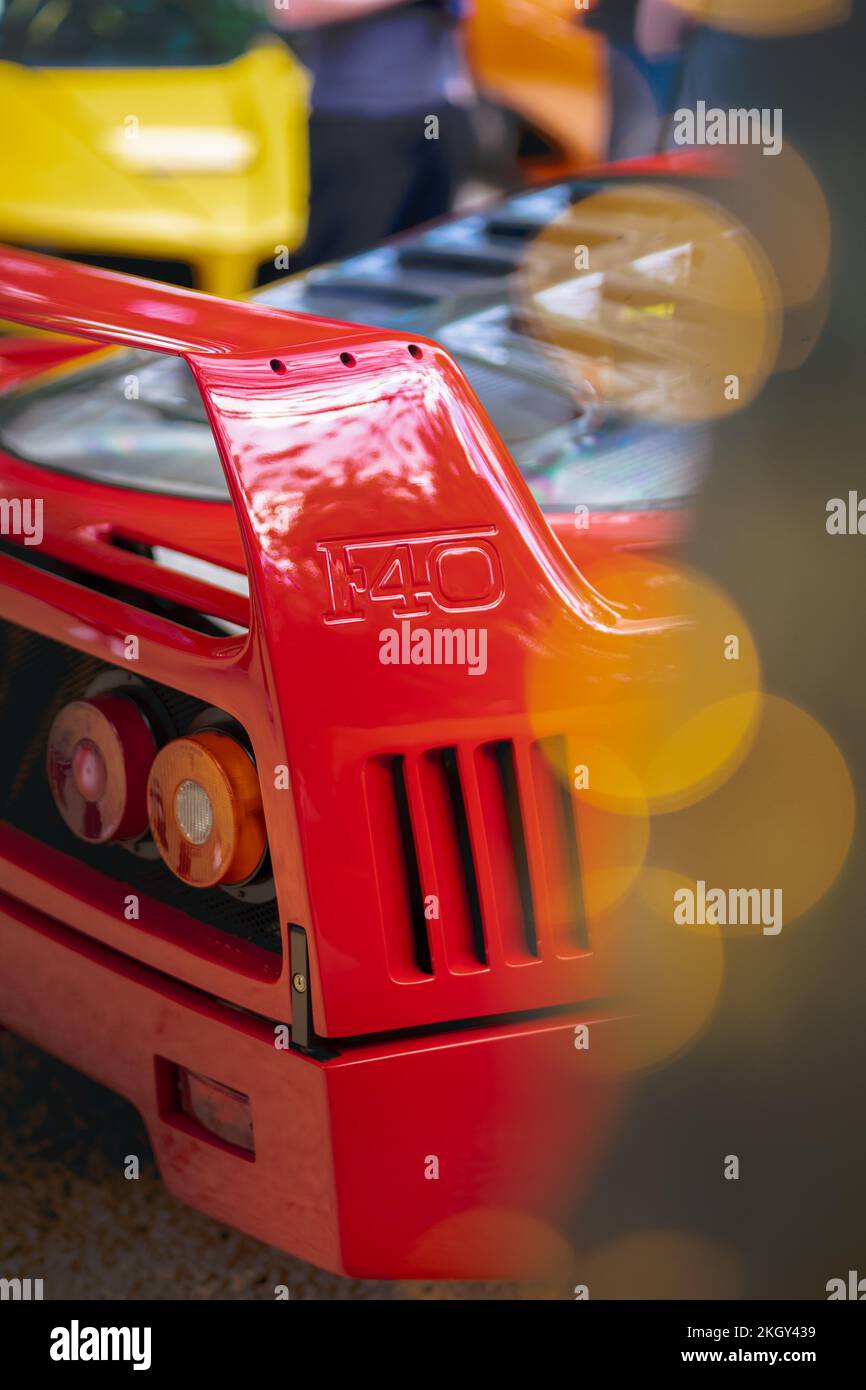 A vertical closeup shot of the wing of super modern red Ferrari F40 ...