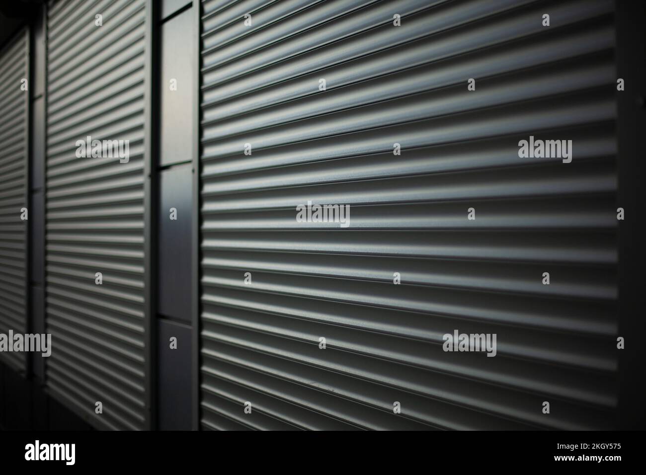 Blinds on windows of store. Steel blinds for large windows. Ribbed ...