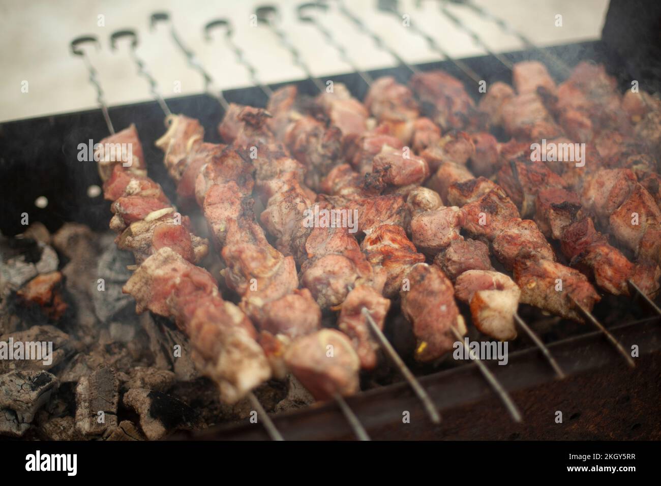 Meat is fried outside. Raw meat planted on blades. Heating food on ...
