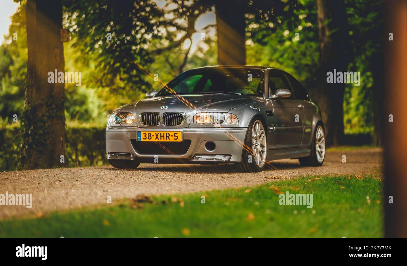 A super modern BMW M3 CSL on the road surrounded by green plants Stock ...