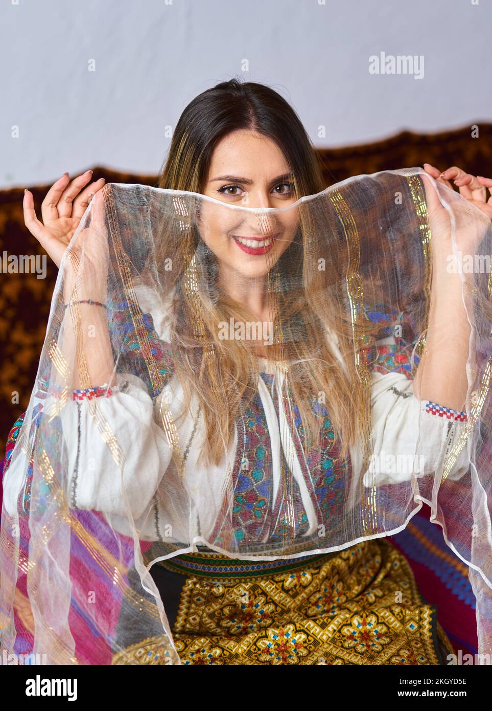 Young Romanian woman dressed up in traditional popular costume, in a ...