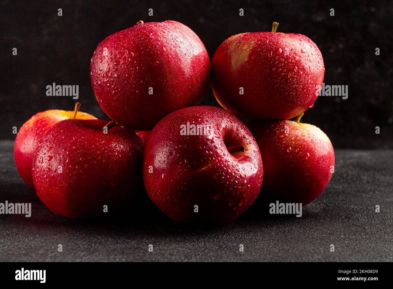 Fresh ripe red apples on a dark background, side view Stock Photo - Alamy