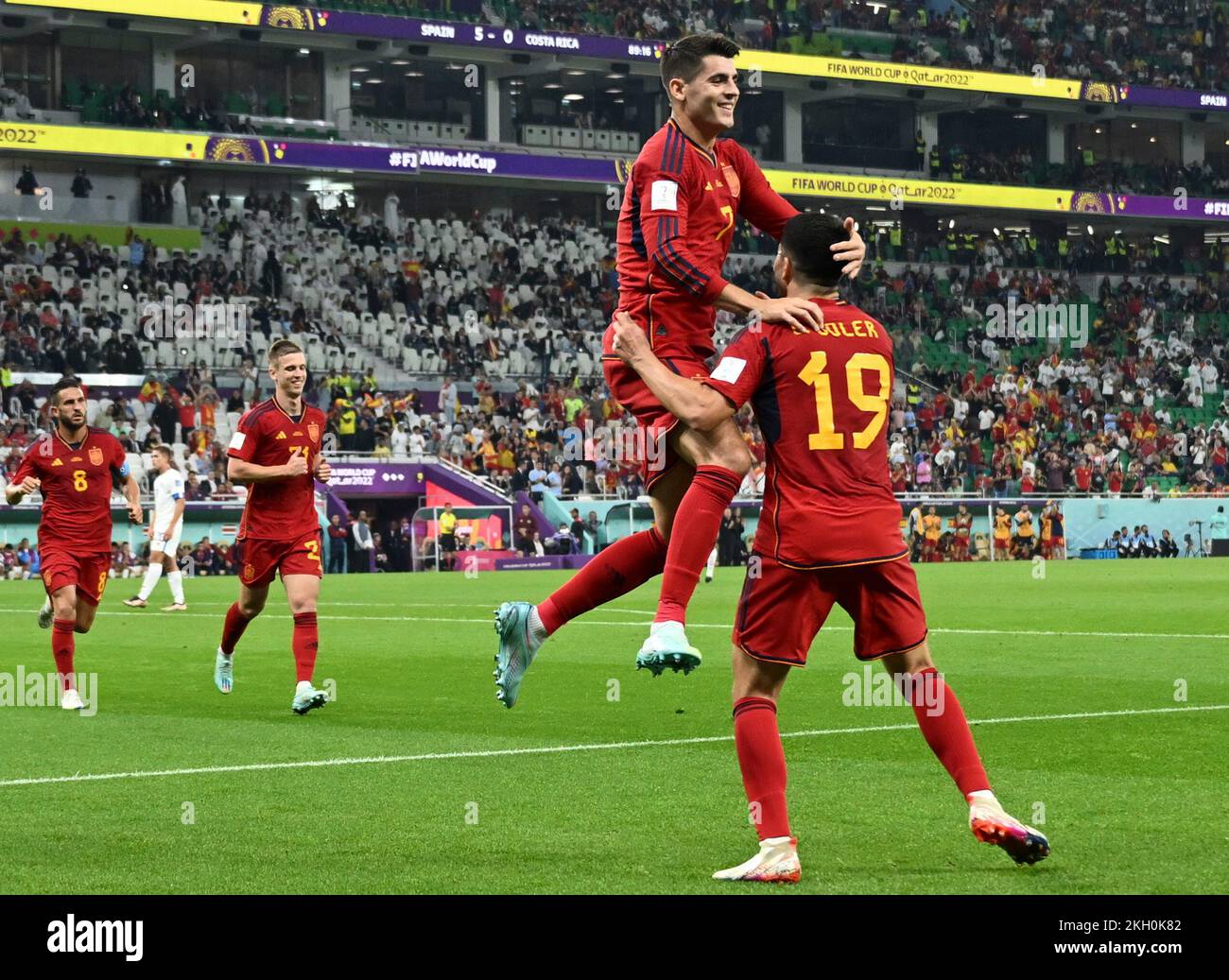 Doha, Qatar. 23rd Nov, 2022. Alvaro Morata (2nd R), Carlos Soler (R) of Spain, celebrate after ...
