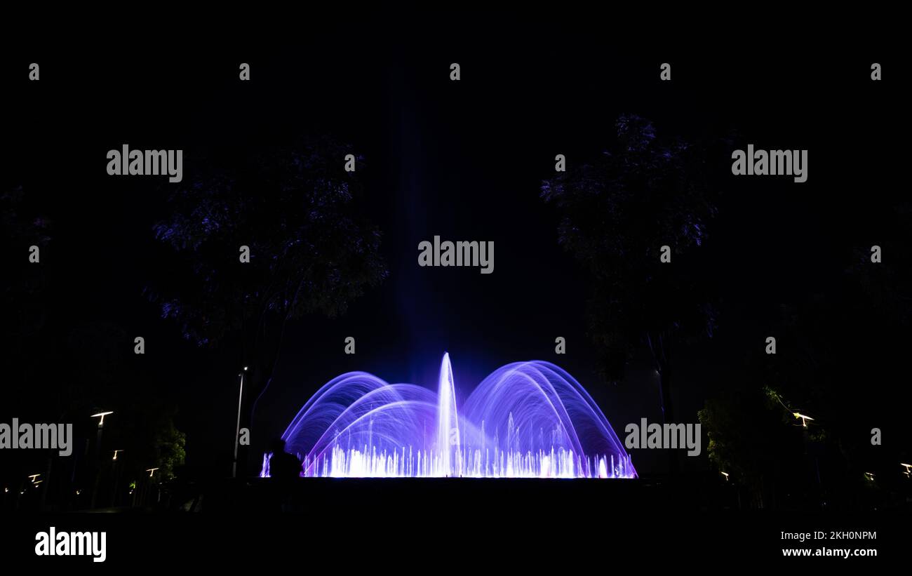 A long exposure shot of an illuminated fountain at night Stock Photo ...