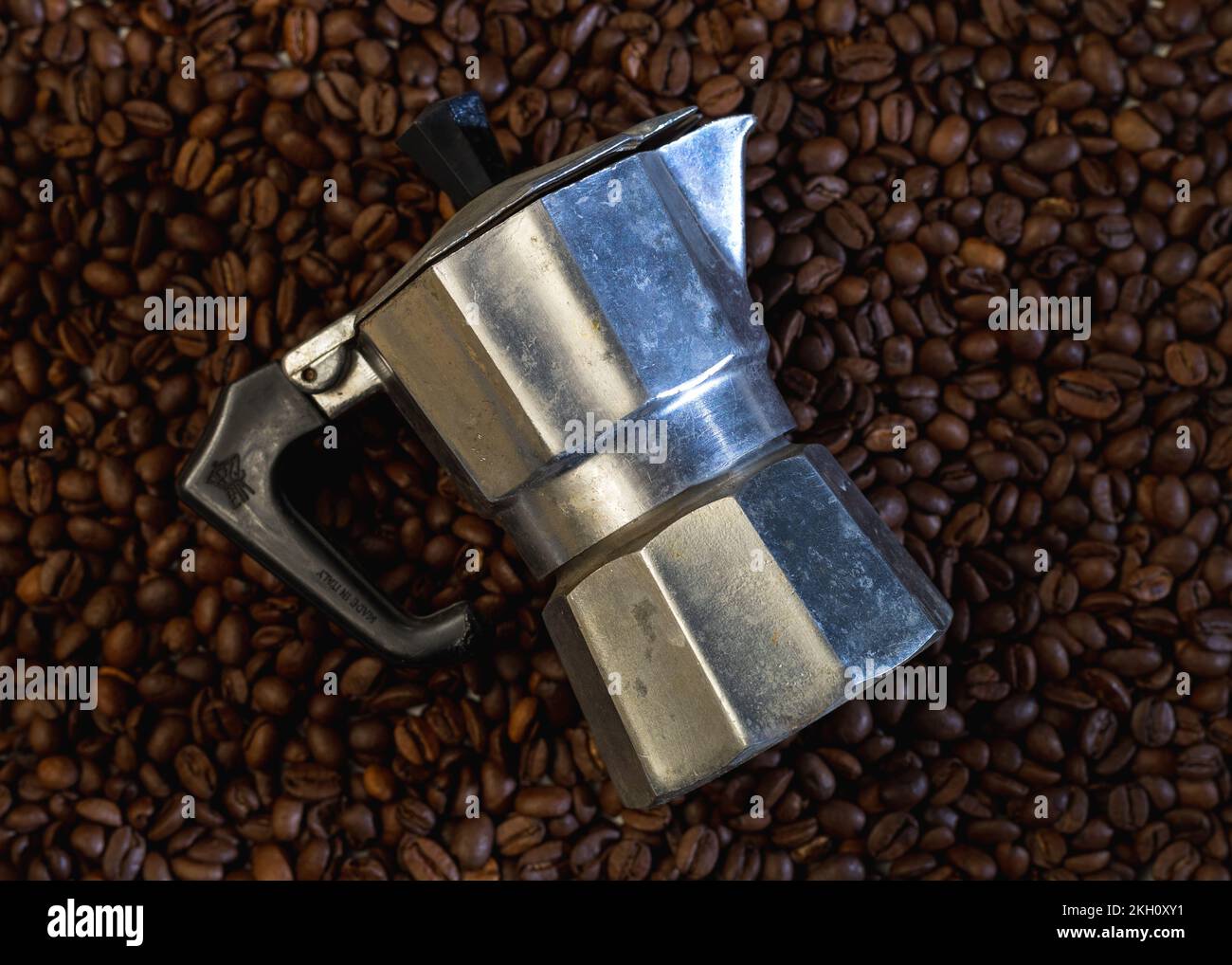 Italian geyser coffee maker on a background of coffee beans Stock Photo ...