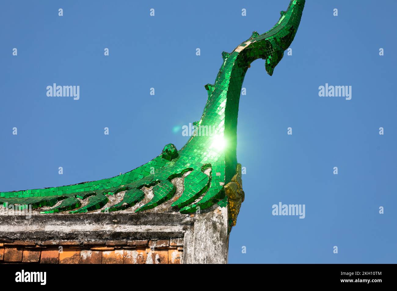 Roof topped with traditional Dok so faa, decorated with bright green glass, at Wat Xieng Thong ...