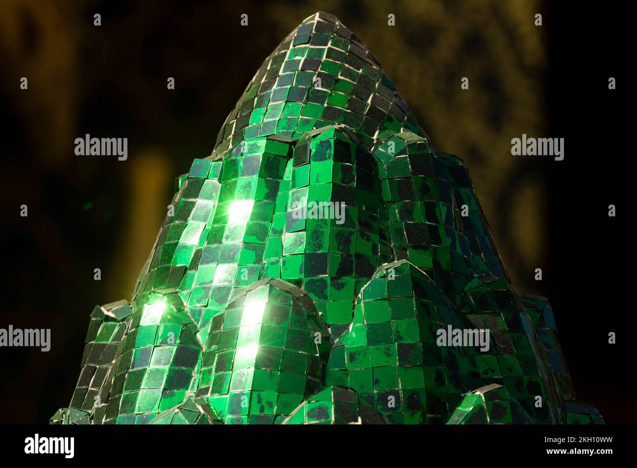 Figure of a fruit or pineapple, decorated with bright green glass, at ...