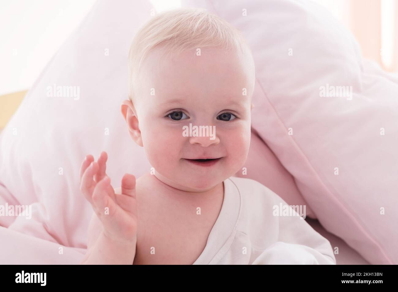 Cute caucasian baby looking at camera smiling. Positive human emotion ...