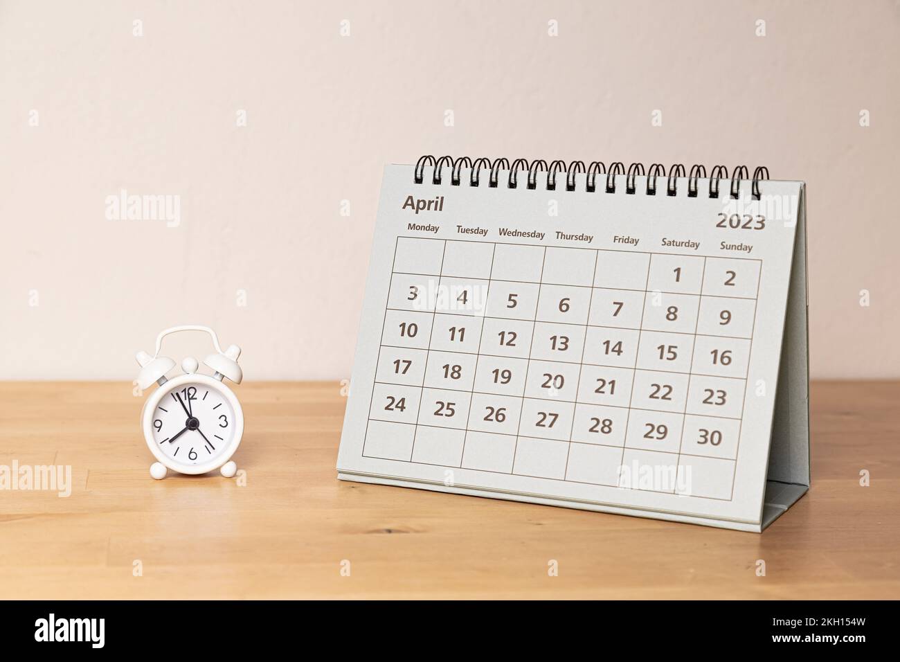 April 2023 calendar and small vintage clock on the desk Stock Photo - Alamy