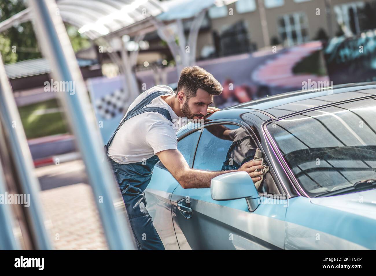 Professional car detailer polishing a customer vehicle by hand Stock ...
