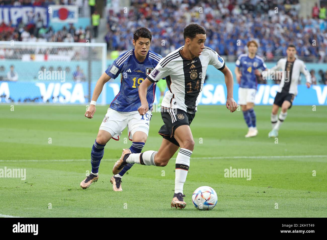 Jamal Musiala of Germany, Hiroki Sakai of Japan (L) during the FIFA ...