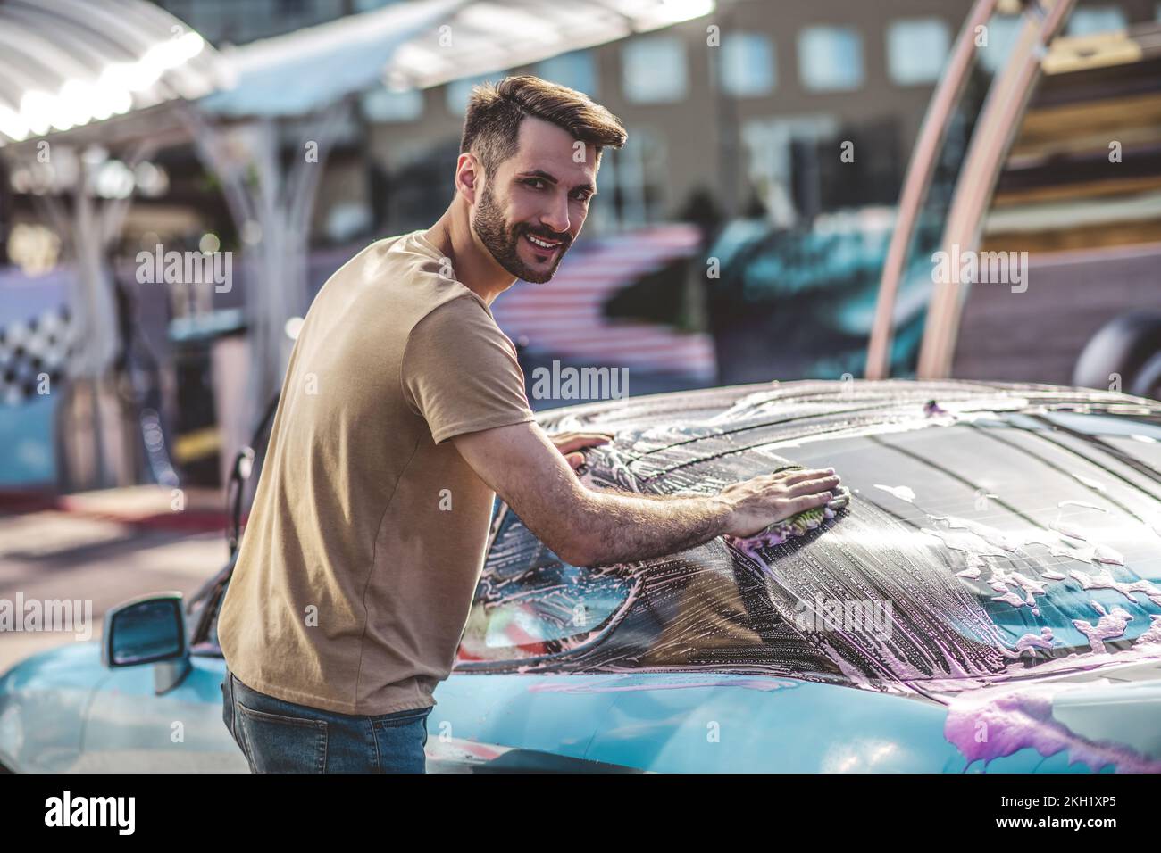 Smiling pleased auto detailer posing for the camera at work Stock Photo ...