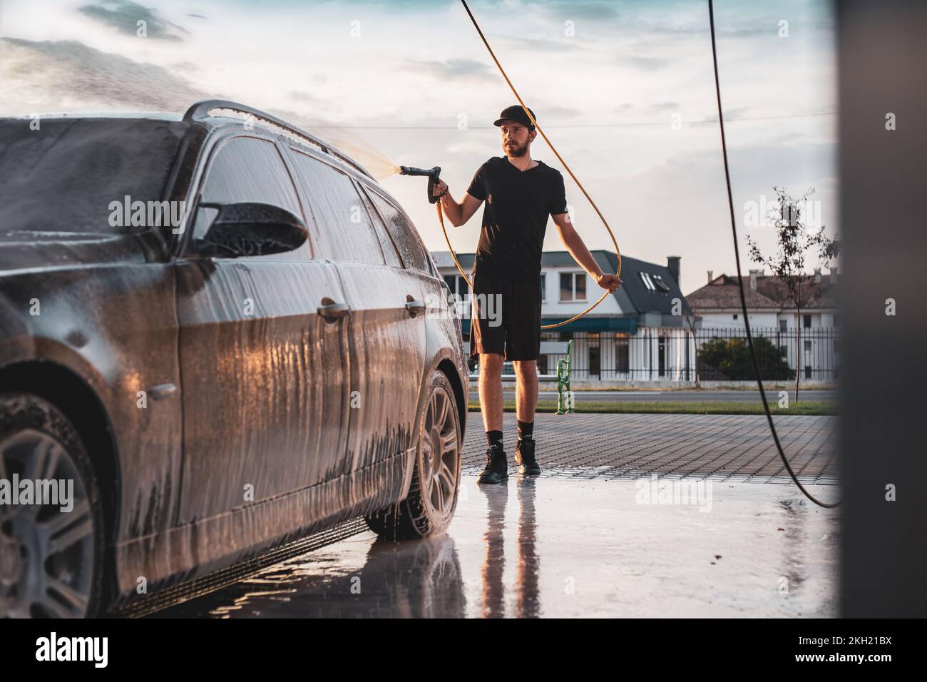 A man washing his car. A young boy taking care of his car Stock Photo ...