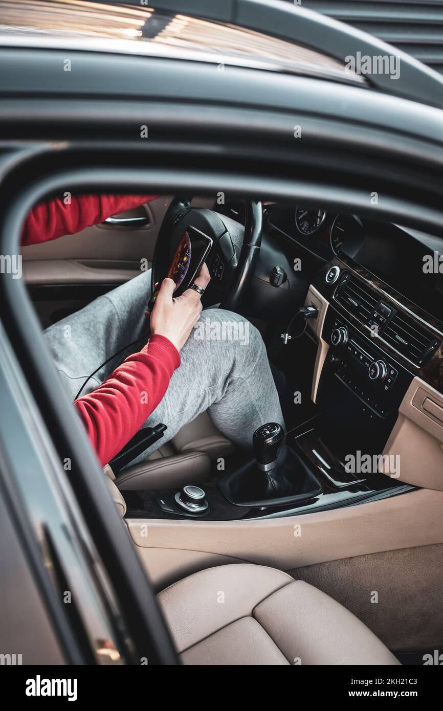 Young boy using his phone in the freshly cleaned car Stock Photo - Alamy