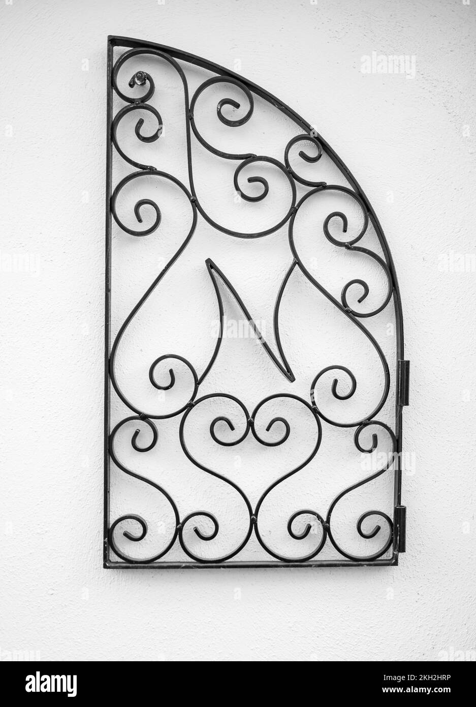 Decorative wrought iron hanging on the white wall. Wrought iron ...
