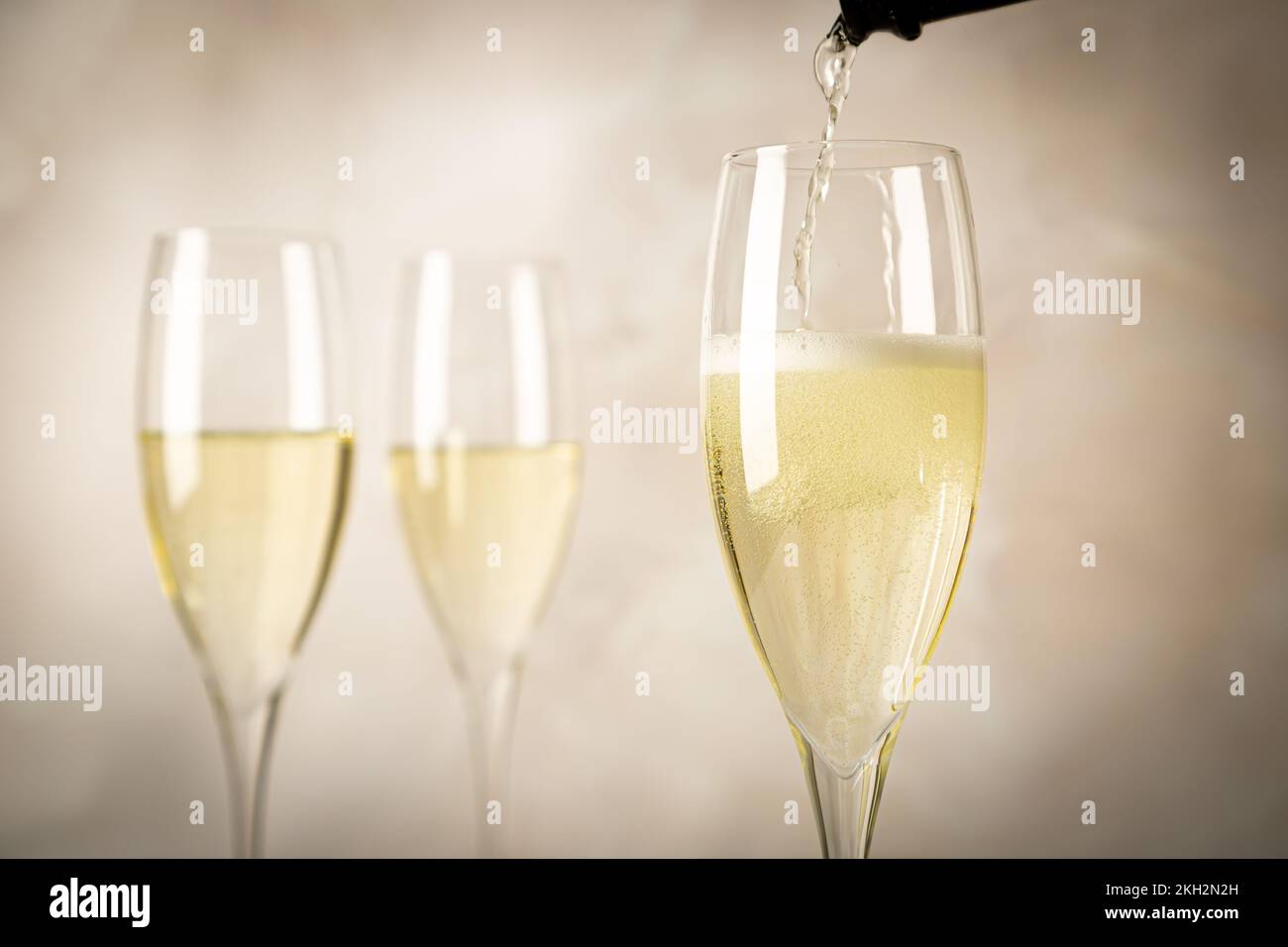 Festive photo of pouring sparkling wine into glasses Stock Photo - Alamy