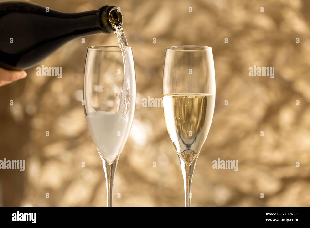 Festive photo of pouring sparkling wine into glasses Stock Photo - Alamy