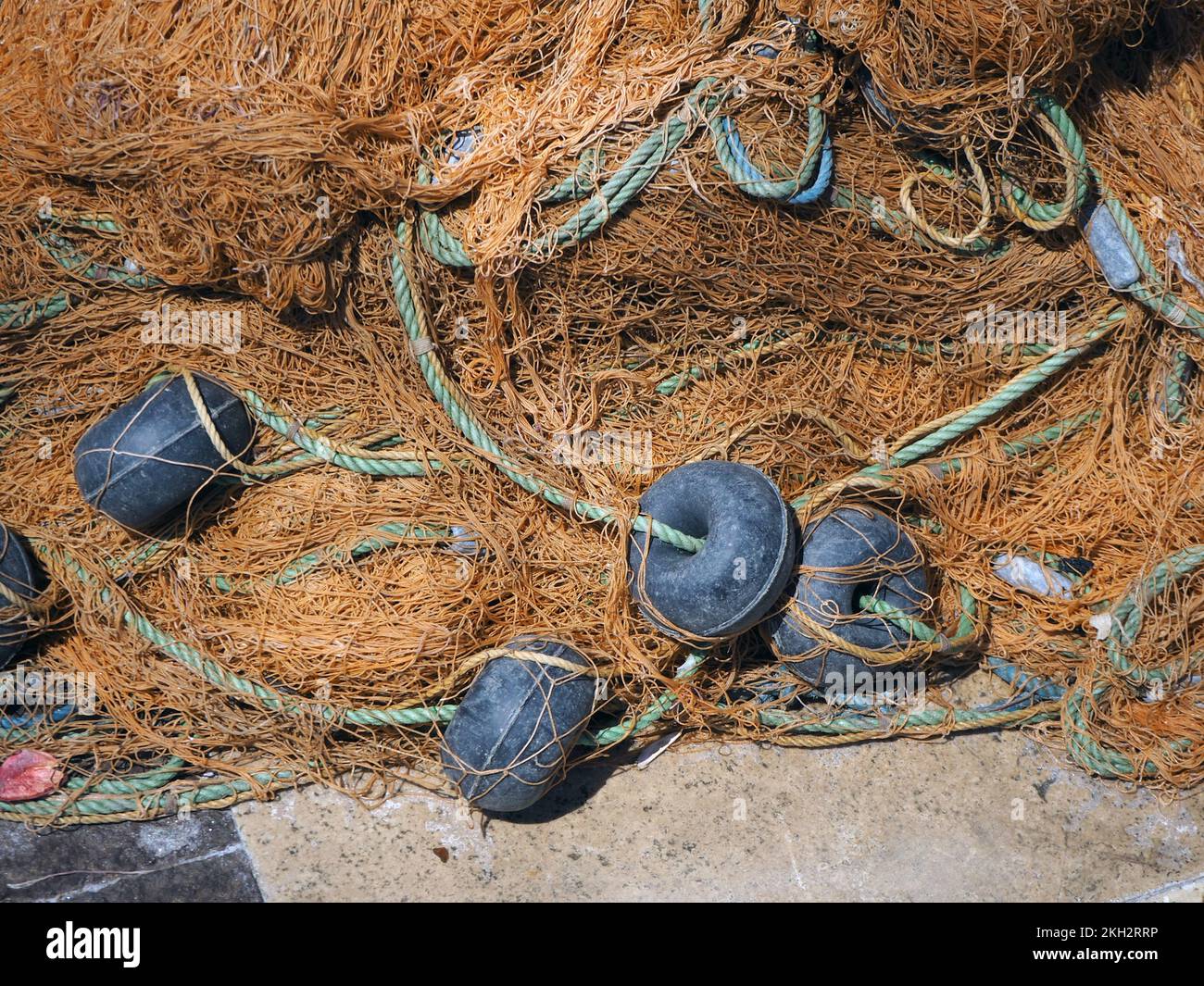 A pile of nets and floats on a fishing boat. Fishing net stack with its ...