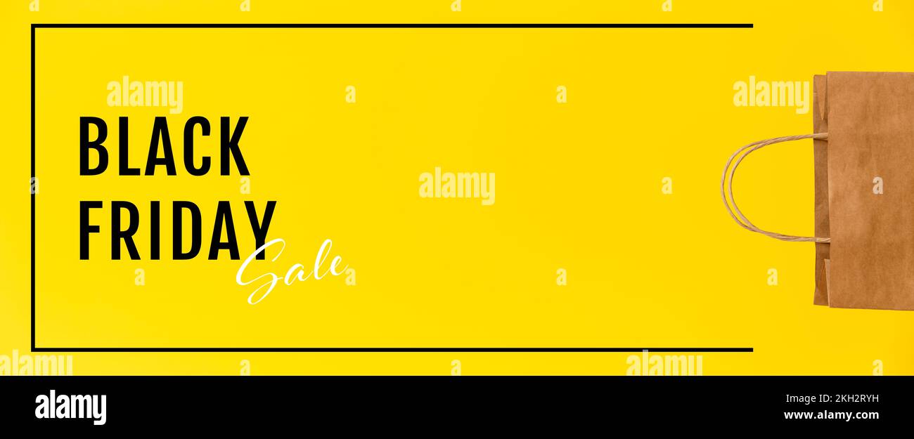 Black Friday sale banner. Brown craft paper bag on yellow background ...