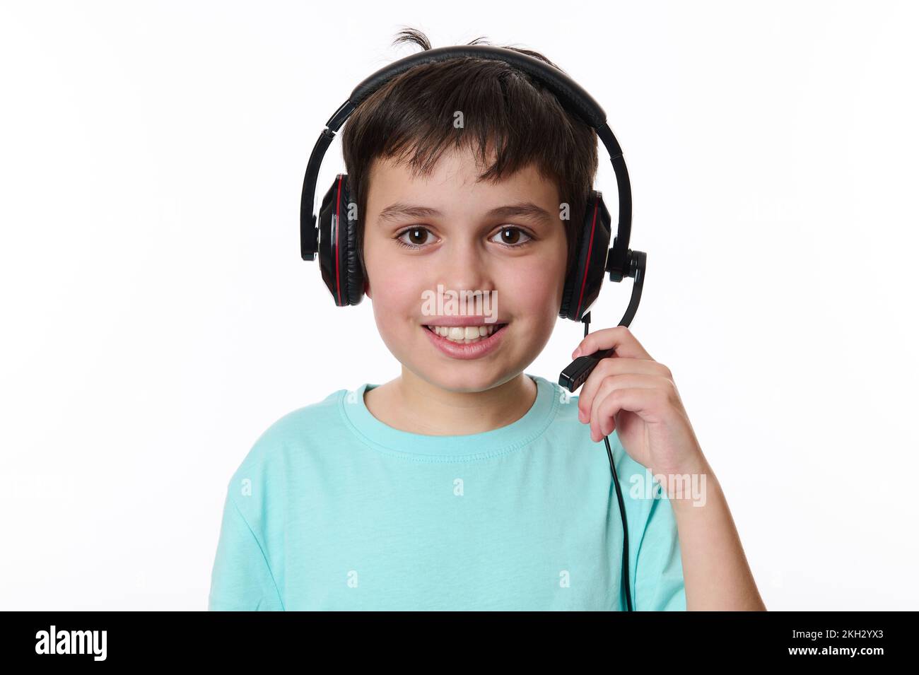 Close-up Caucasian smart teenage school boy, in audio headset, ready ...