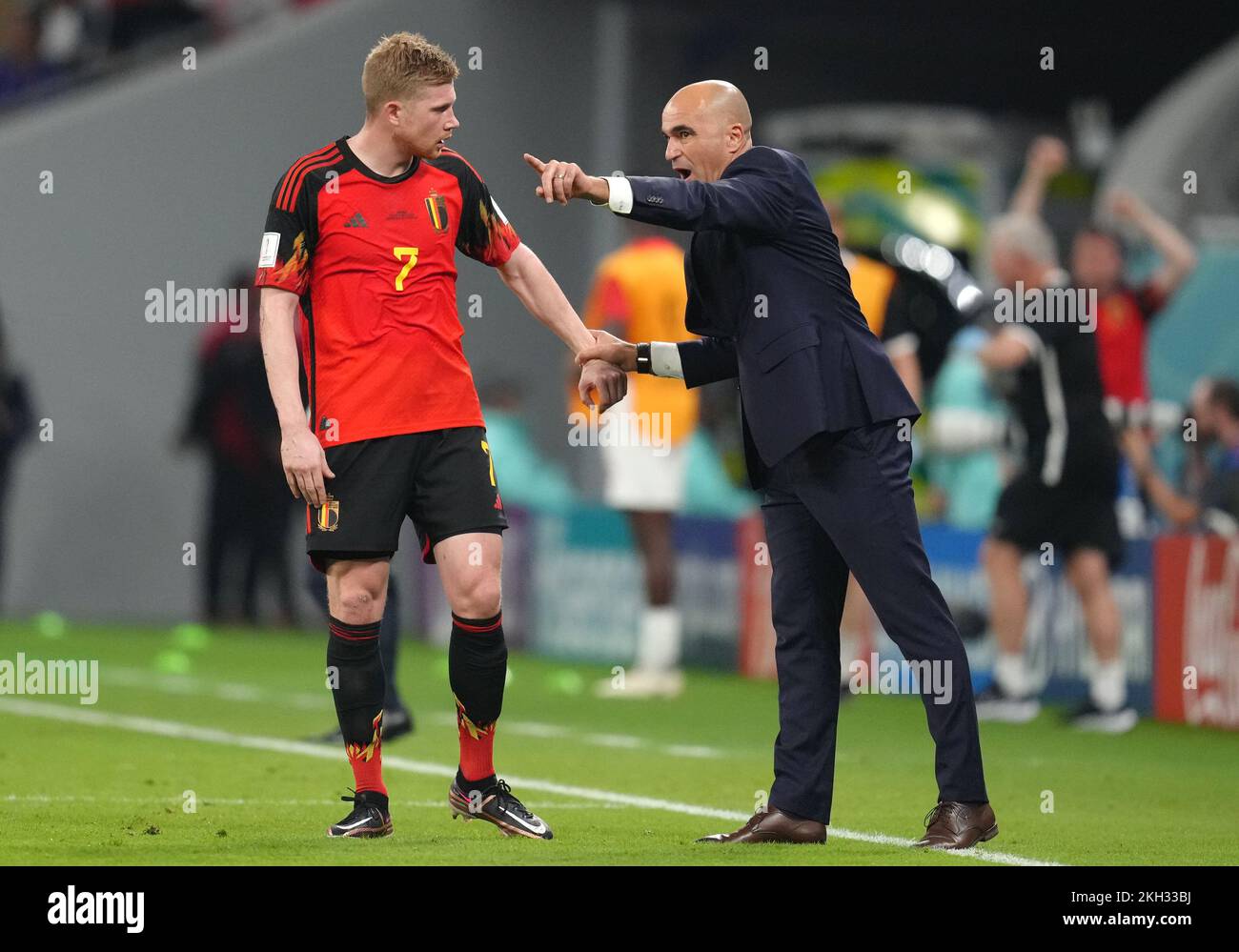 Belgium's Kevin De Bruyne (left) and manager Roberto Martinez exchange ...