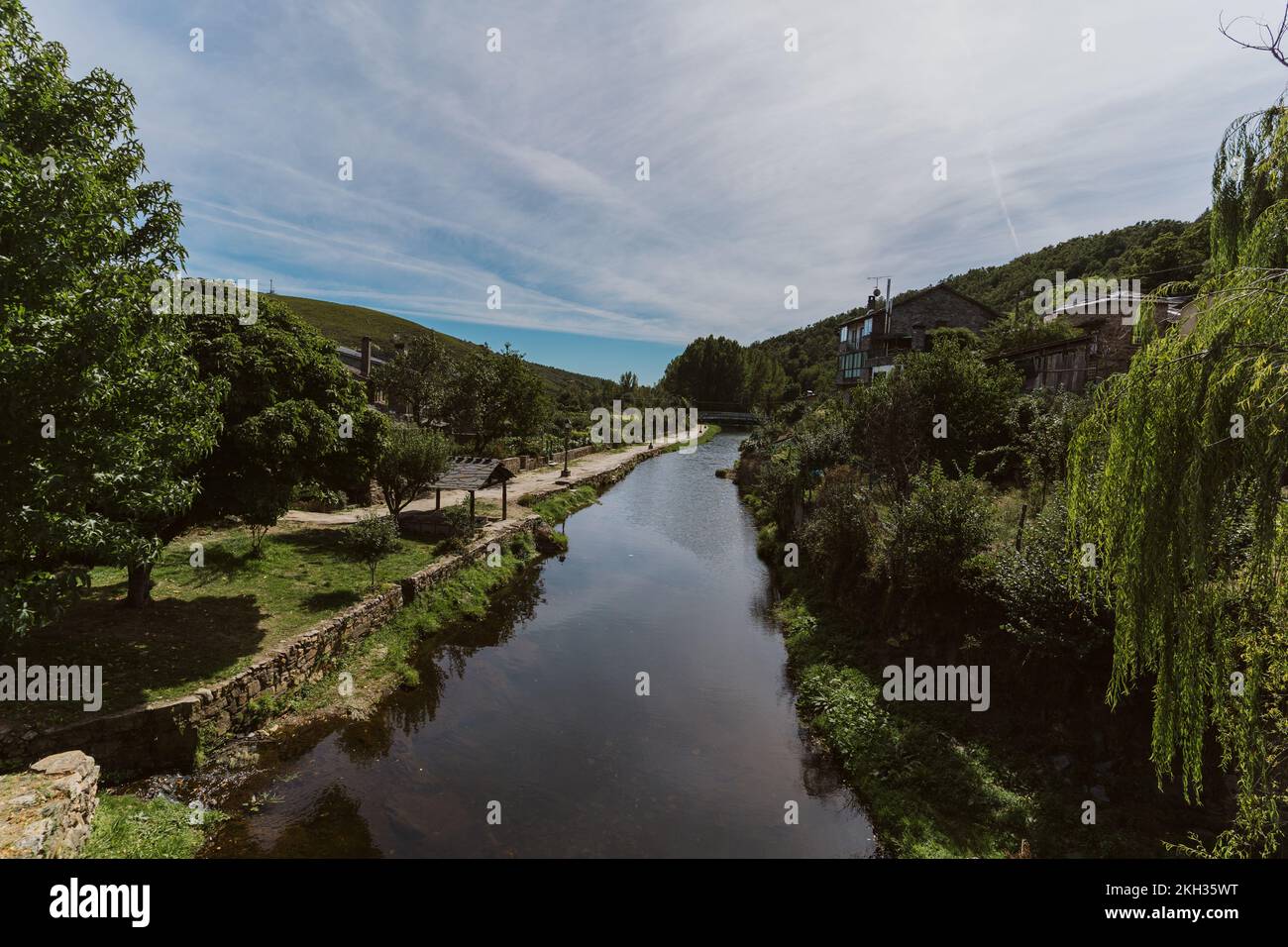 A mesmerizing shot of a river in Rio de Onor village, surrounded by ...